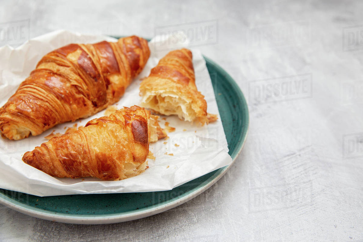 Plate of croissants, whole and broken in half - Royalty-free Stock ...