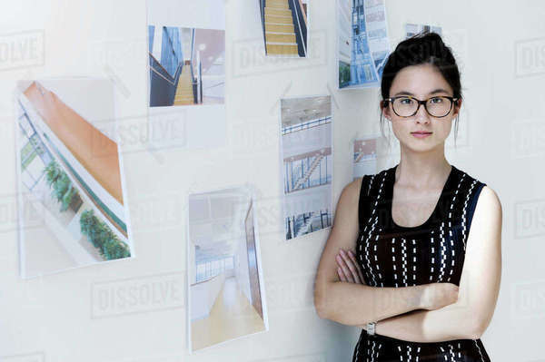 Portrait of young businesswoman with dark brown hair wearing glasses ...