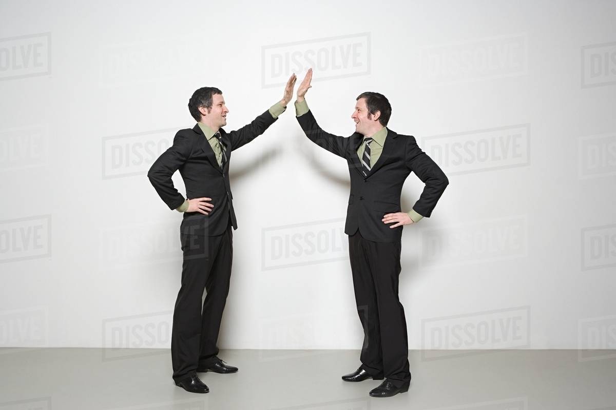 Men doing high five - Royalty-free Stock Photo | Dissolve