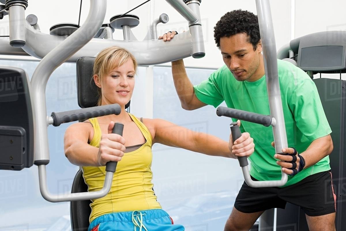 Woman and fitness instructor - Stock Photo - Dissolve