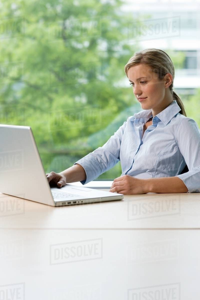 Office worker with laptop - Royalty-free Stock Photo | Dissolve