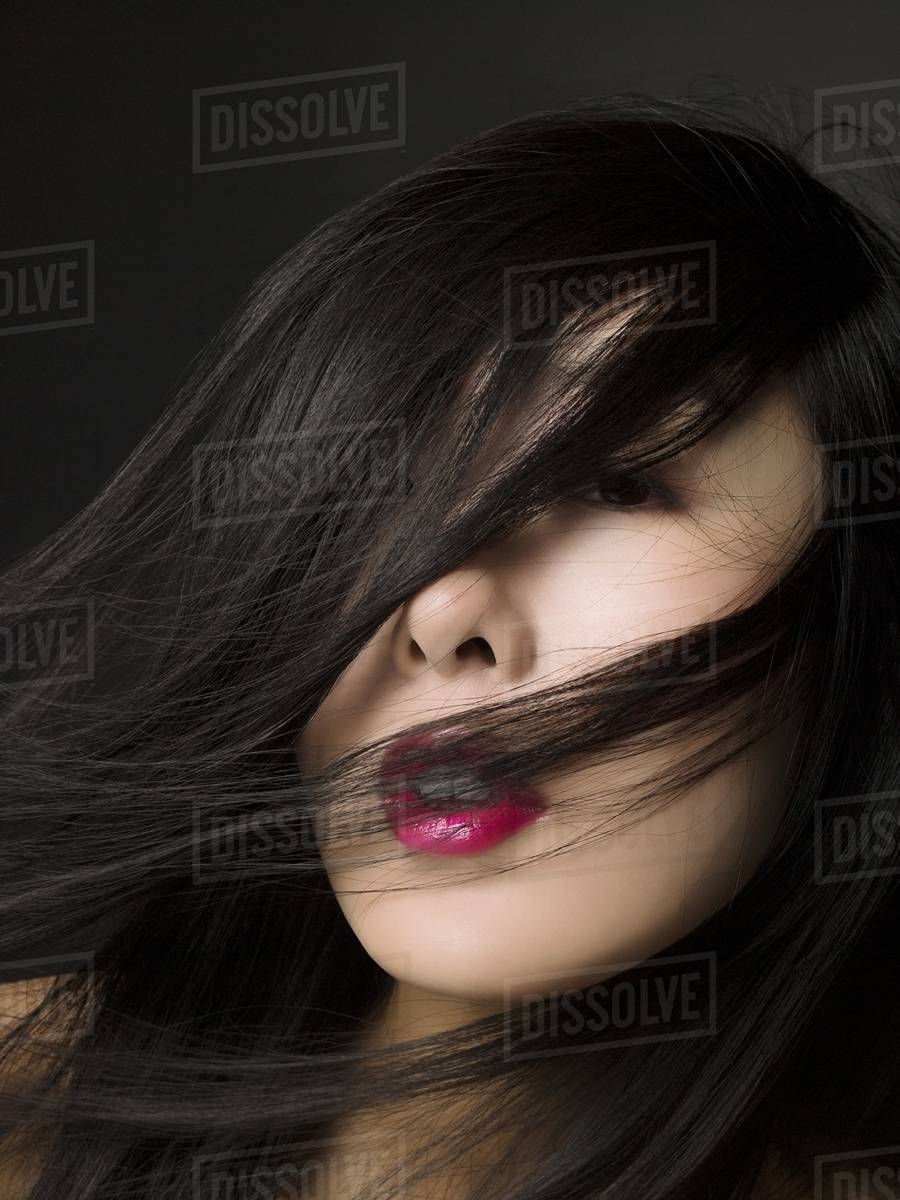 Woman with hair over her face - Royalty-free Stock Photo | Dissolve