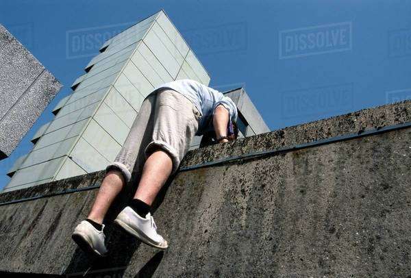 Person going over wall - Royalty-free Stock Photo | Dissolve