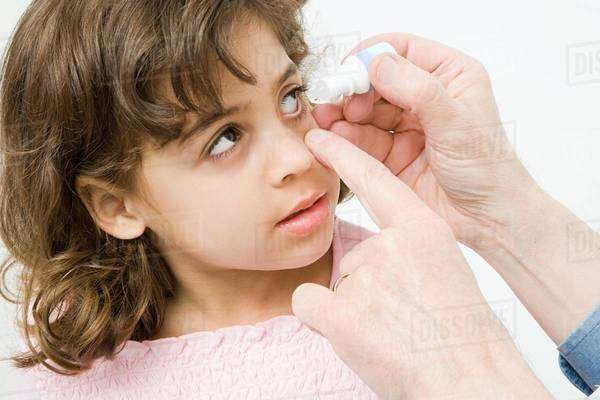 Girl having eye drops put in - Royalty-free Stock Photo | Dissolve