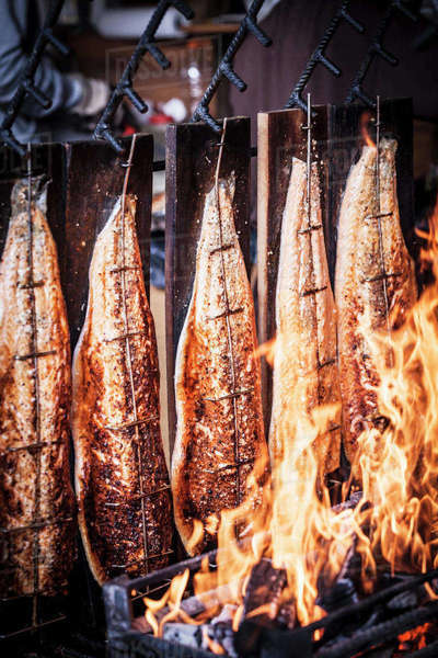 Fish cooking on open fire in street market, Basel, Switzerland ...