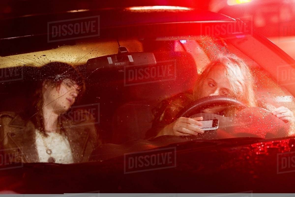 Two young women in a car accident - Royalty-free Stock Photo | Dissolve