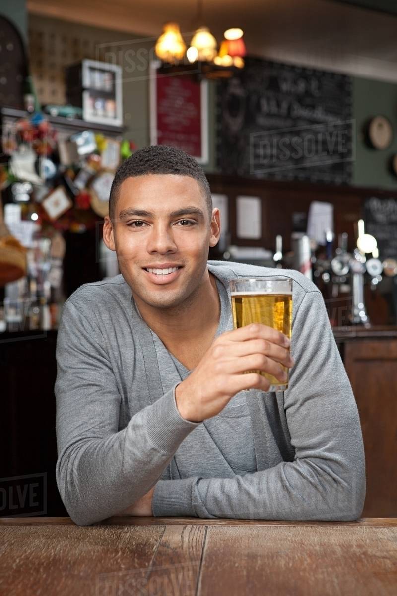Young man in bar - Royalty-free Stock Photo | Dissolve