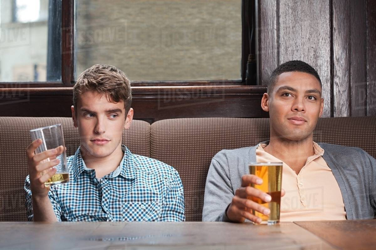 Two young men in bar - Royalty-free Stock Photo | Dissolve