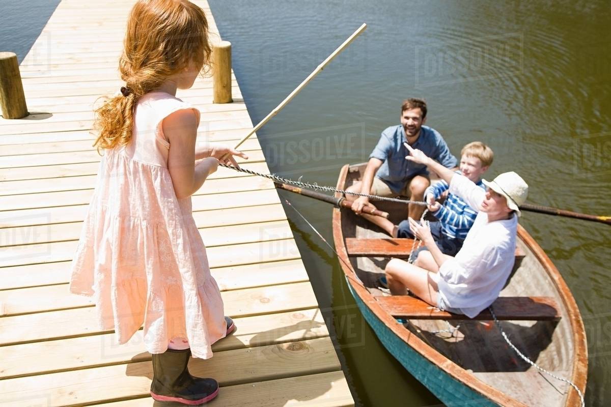 Family with rowing boat - Royalty-free Stock Photo | Dissolve
