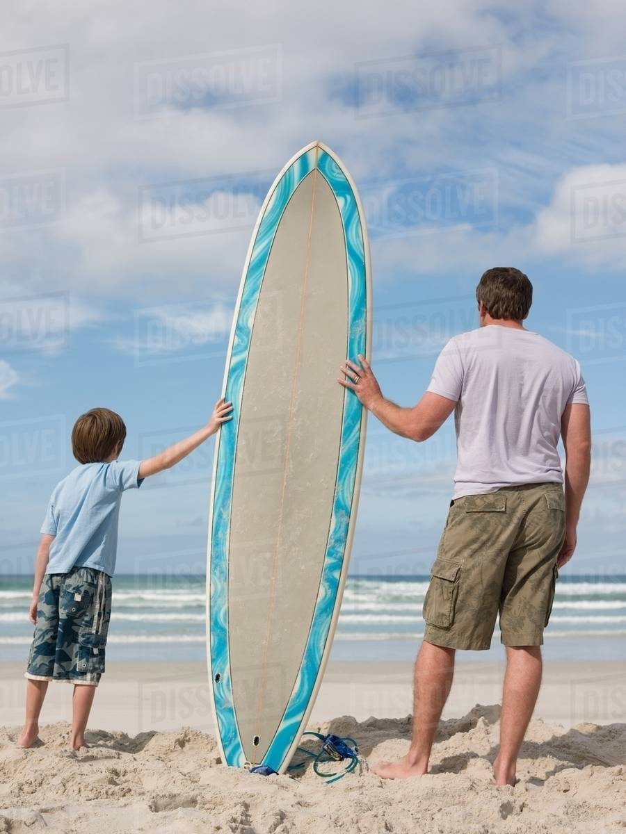 Father and son with surfboard - Royalty-free Stock Photo | Dissolve