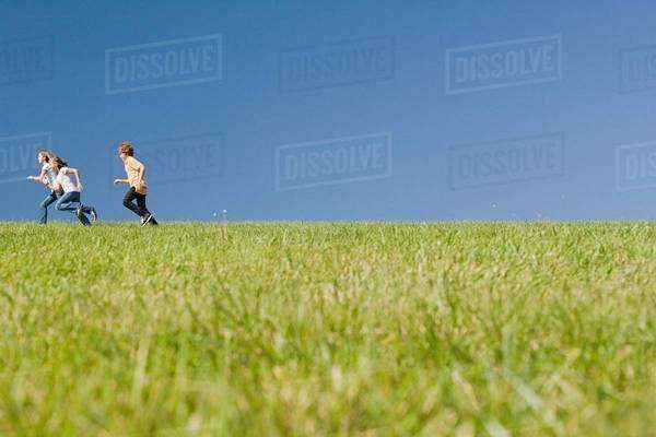 Children running in field - Royalty-free Stock Photo | Dissolve