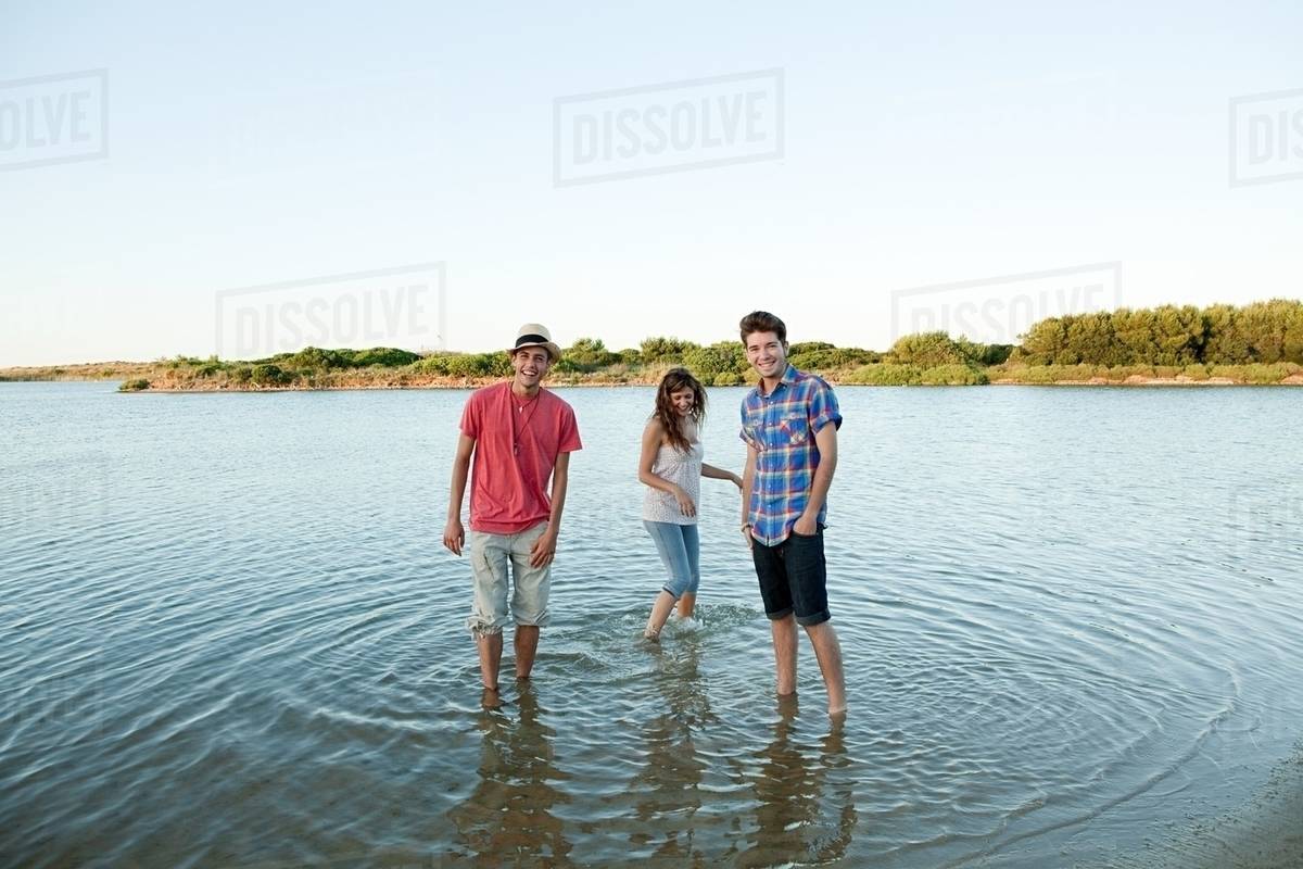 Three friends having fun in lake - Royalty-free Stock Photo | Dissolve