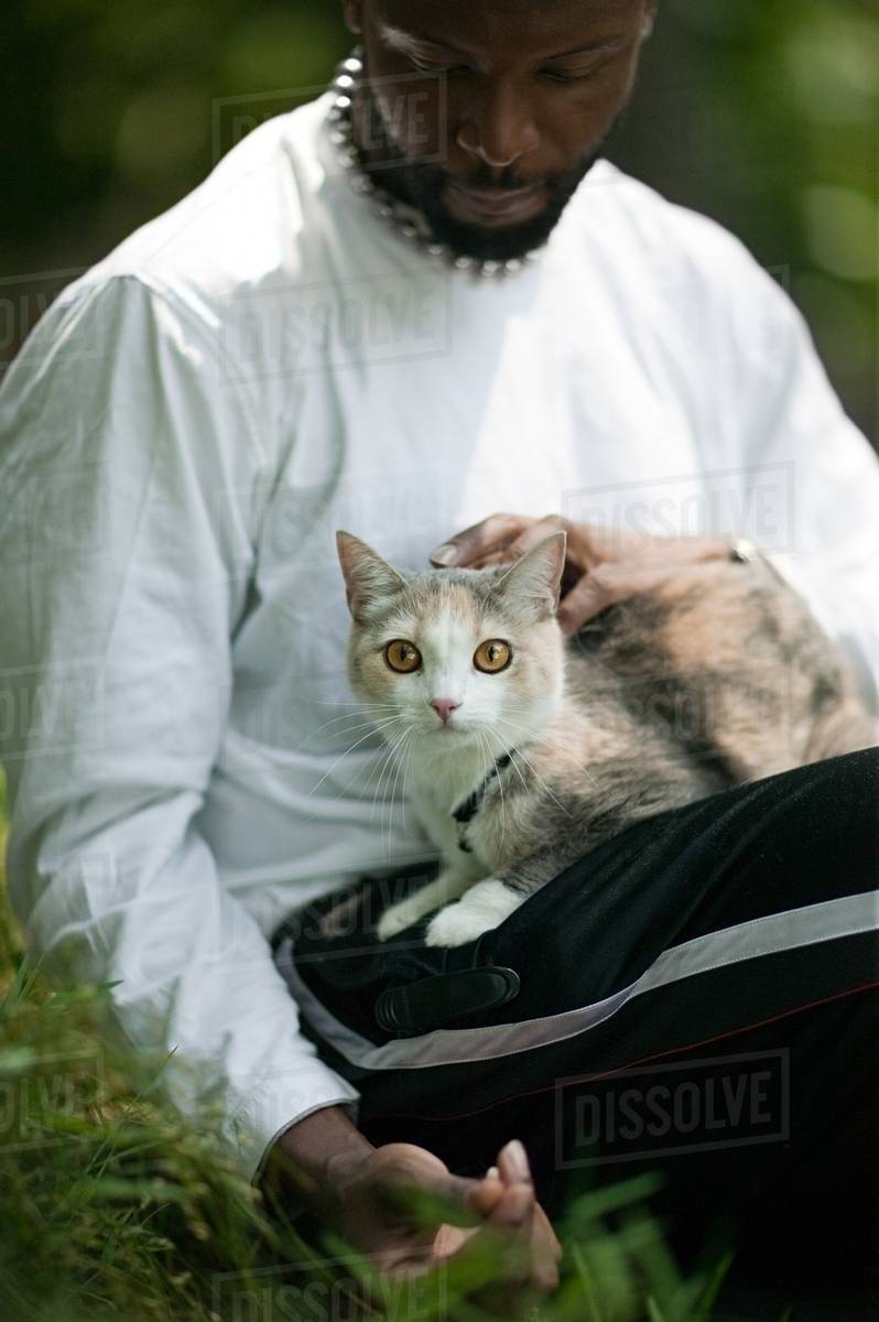 Man petting his cat - Royalty-free Stock Photo | Dissolve