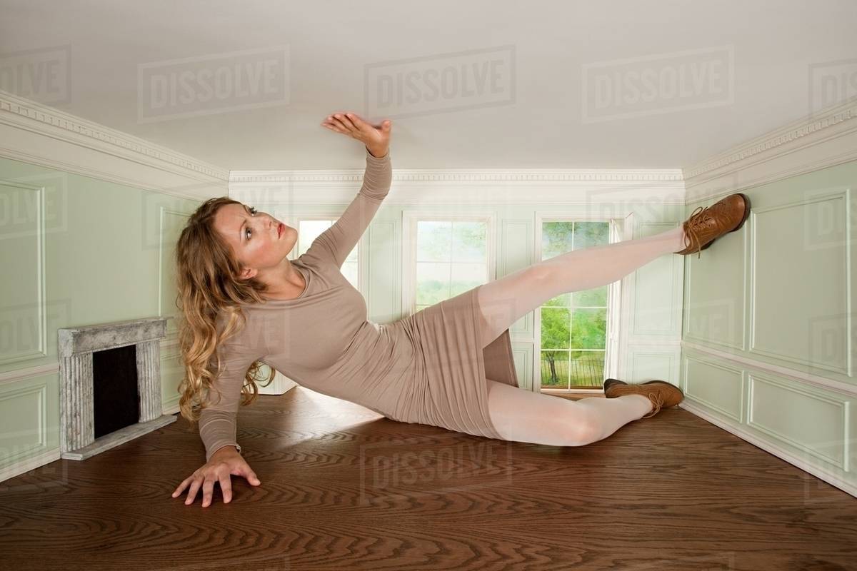 Giant young woman trapped in small room - Royalty-free Stock Photo ...