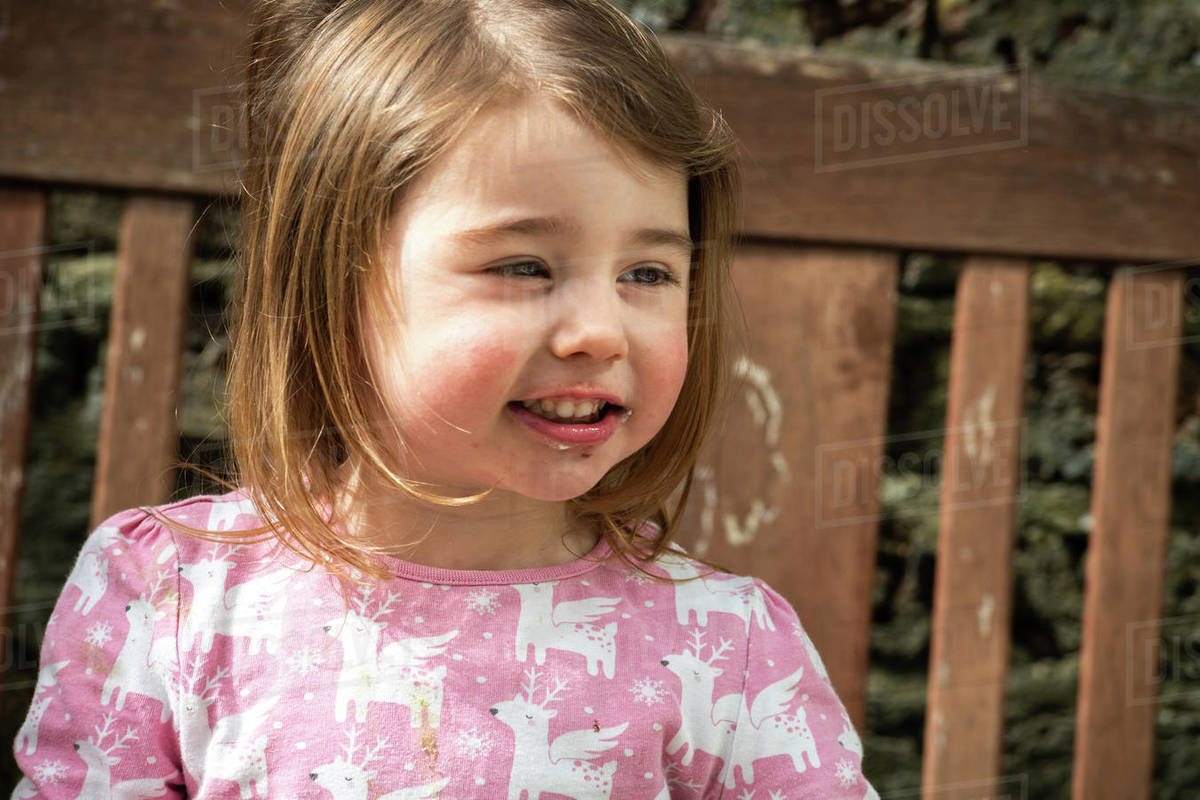 UK, Portrait of smiling girl outdoors - Royalty-free Stock Photo | Dissolve