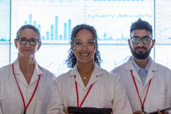 Portrait of smiling researchers at interactive screens - Stock Photo ...