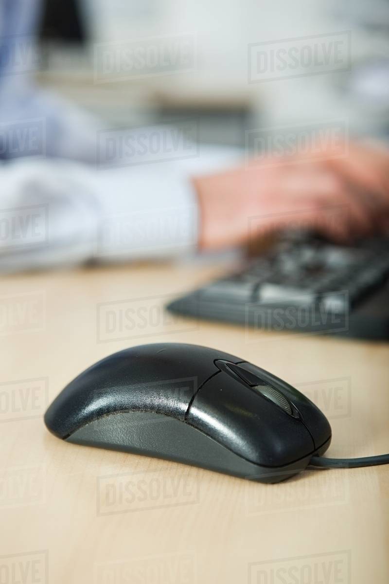 Office worker using computer, mouse in foreground - Royalty-free Stock ...