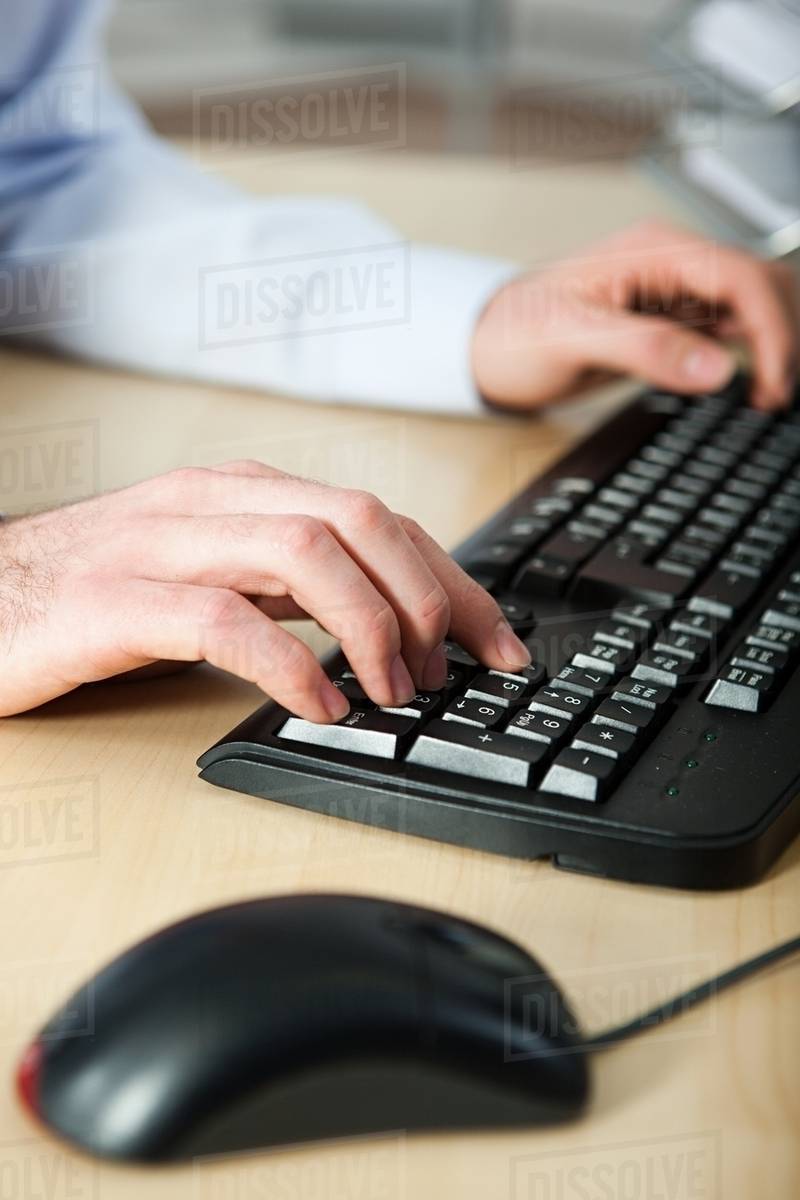 Office worker using computer - Stock Photo - Dissolve