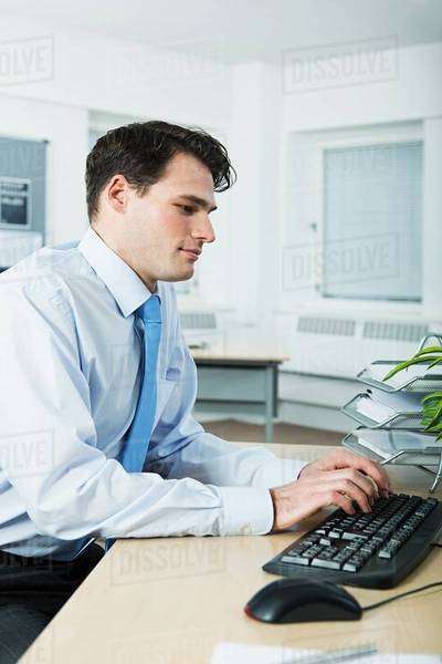 Office worker using computer - Royalty-free Stock Photo | Dissolve