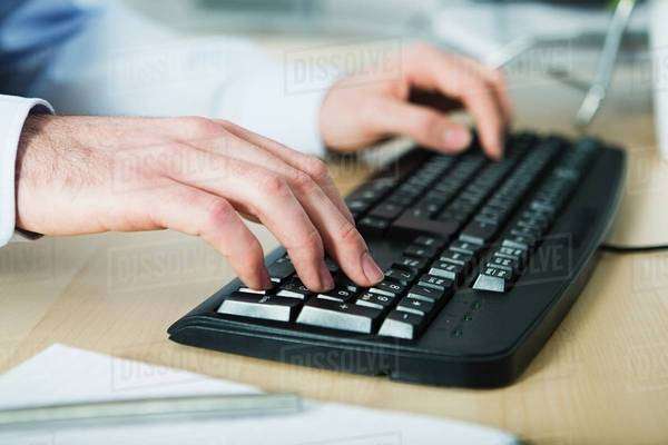 Office worker using computer - Stock Photo - Dissolve