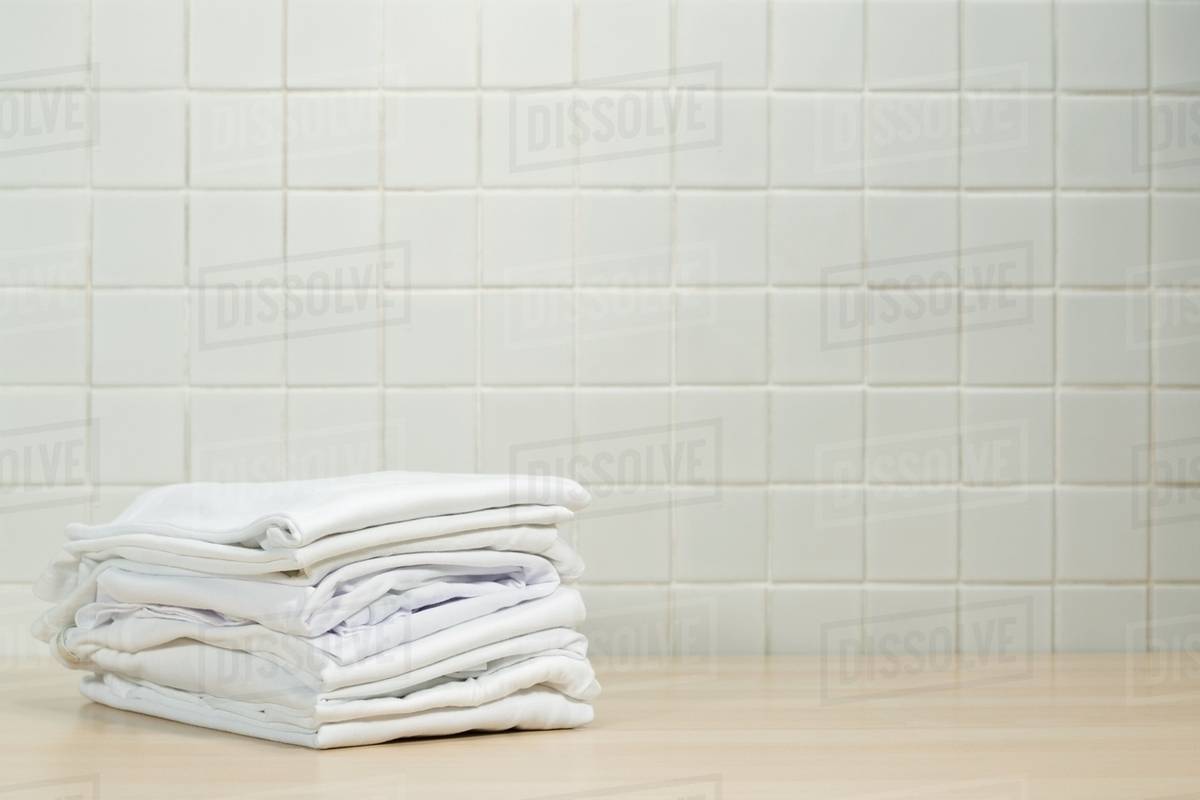 Piles of clean white laundry - Royalty-free Stock Photo | Dissolve