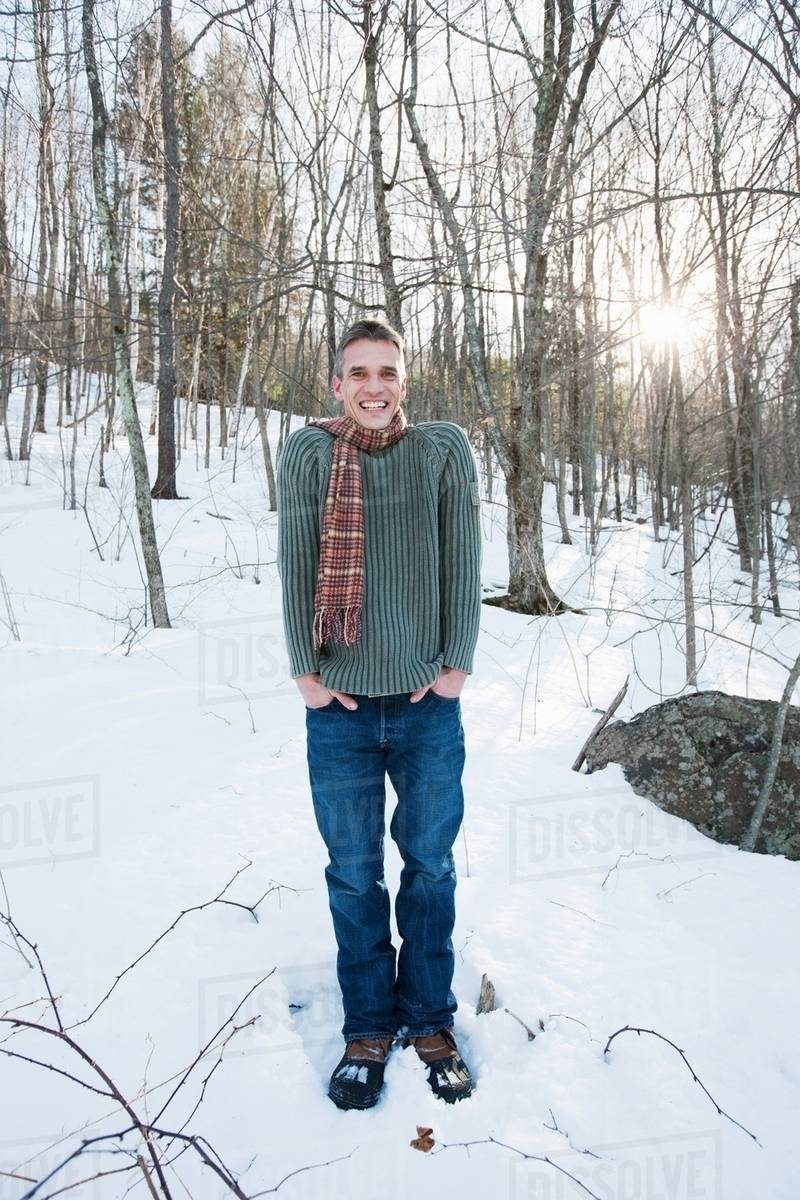 Man standing in snow, portrait - Royalty-free Stock Photo | Dissolve