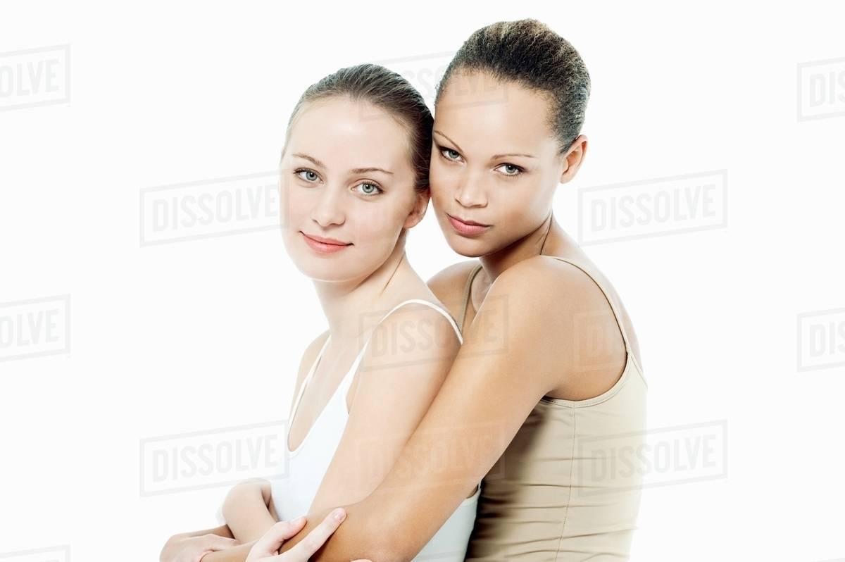 Two young women hugging - Royalty-free Stock Photo | Dissolve