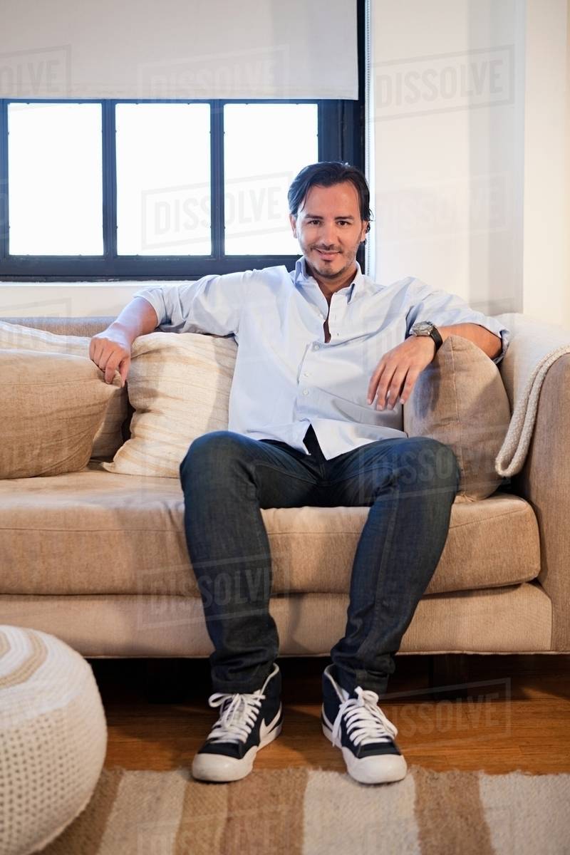 Man sitting on sofa - Royalty-free Stock Photo | Dissolve