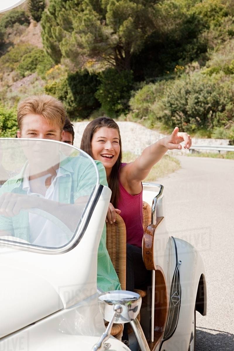 Young people driving convertible car - Royalty-free Stock Photo | Dissolve