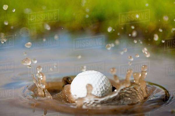 Golf ball splashing into water - Royalty-free Stock Photo | Dissolve