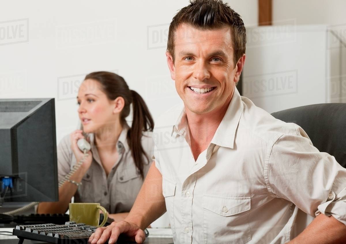 Man getting up from behind his desk - Stock Photo - Dissolve