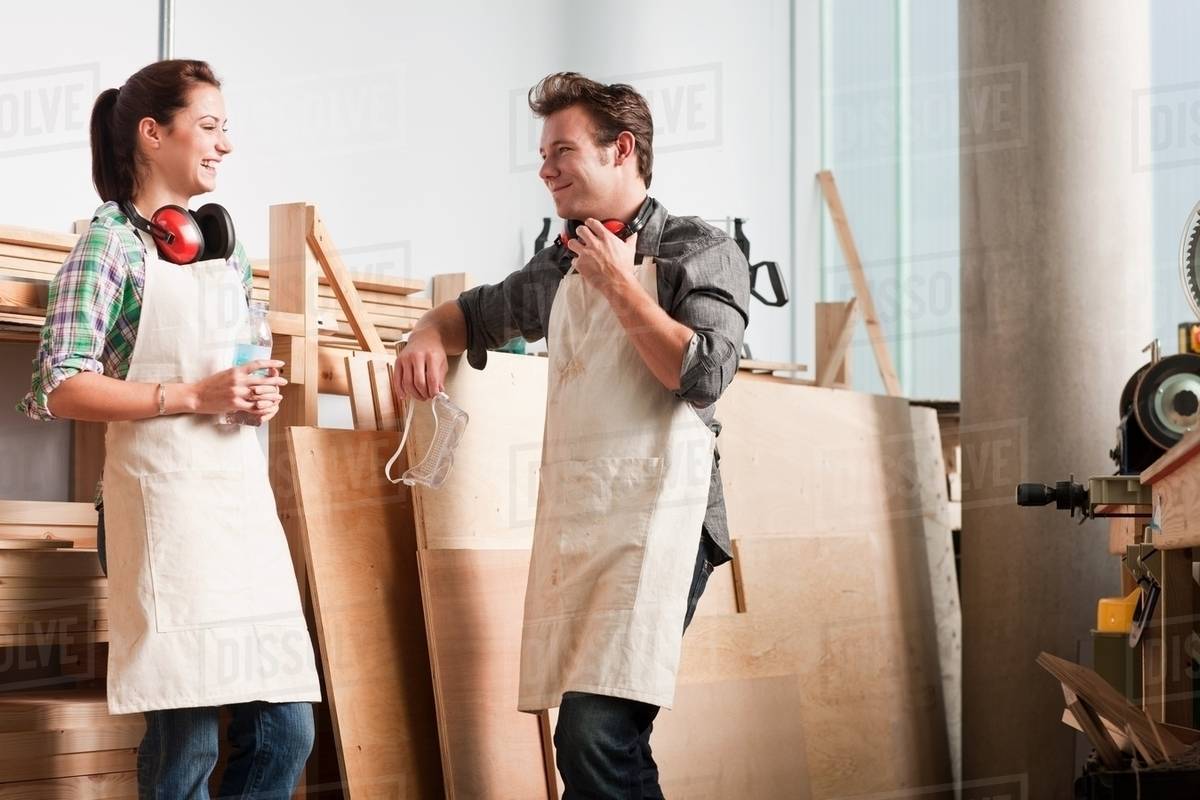 Carpenters talking in workshop - Royalty-free Stock Photo | Dissolve