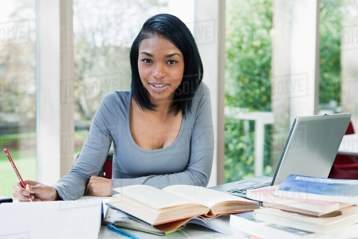 University student writing at desk, portrait - Royalty-free Stock Photo ...