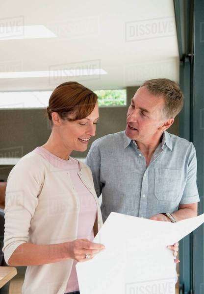 Couple looking at document - Stock Photo - Dissolve