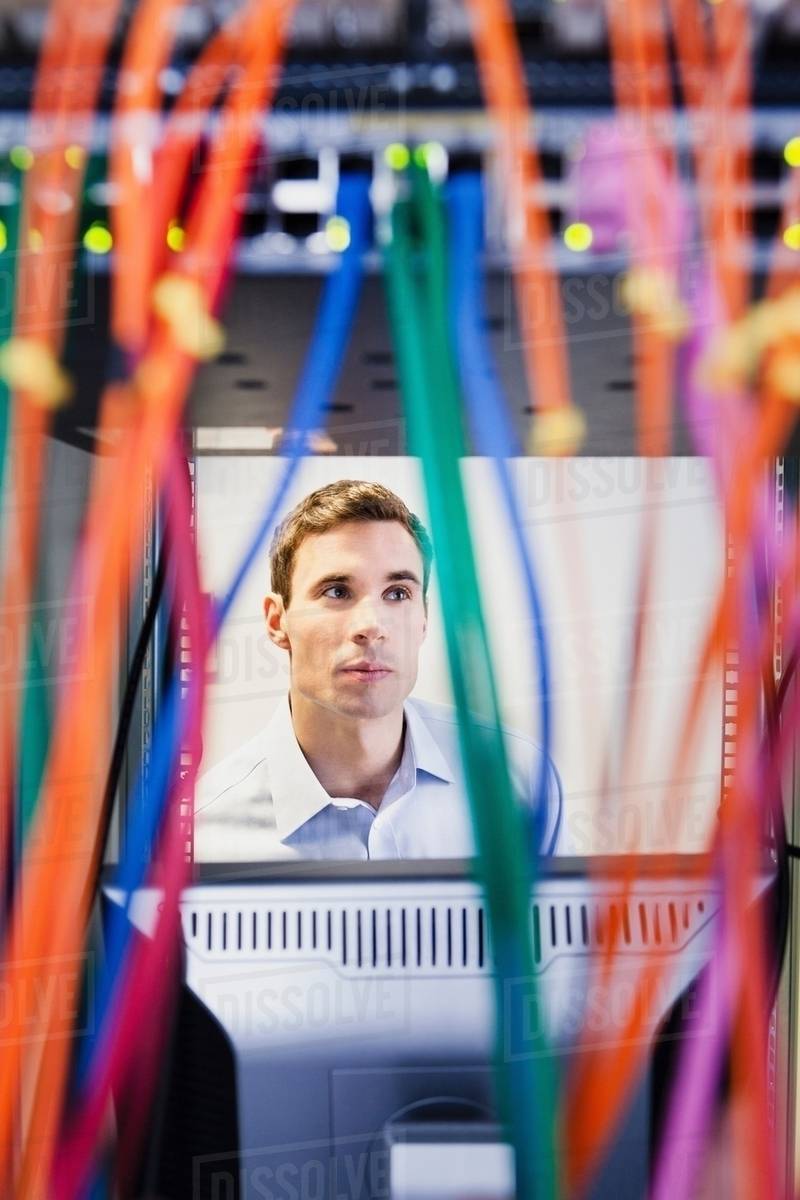Young man in server room - Stock Photo - Dissolve