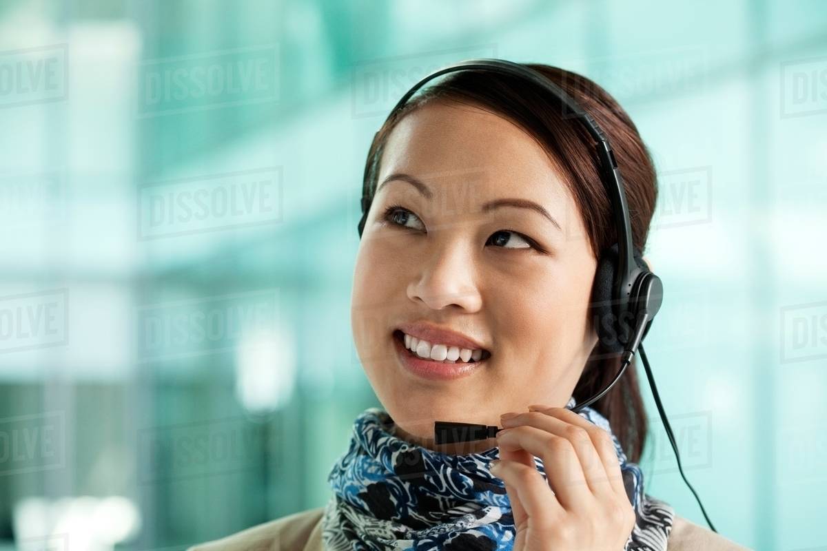 Office worker wearing headset - Royalty-free Stock Photo | Dissolve