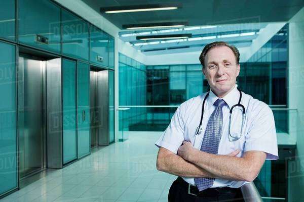 Portrait of doctor with arms folded - Royalty-free Stock Photo | Dissolve
