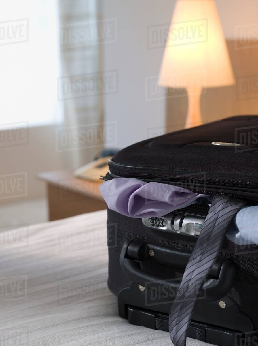 Full suitcase in a hotel room - Royalty-free Stock Photo | Dissolve