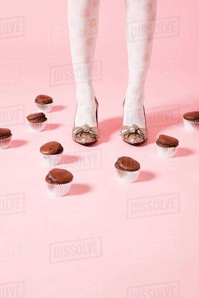 Legs of woman and cakes - Royalty-free Stock Photo | Dissolve