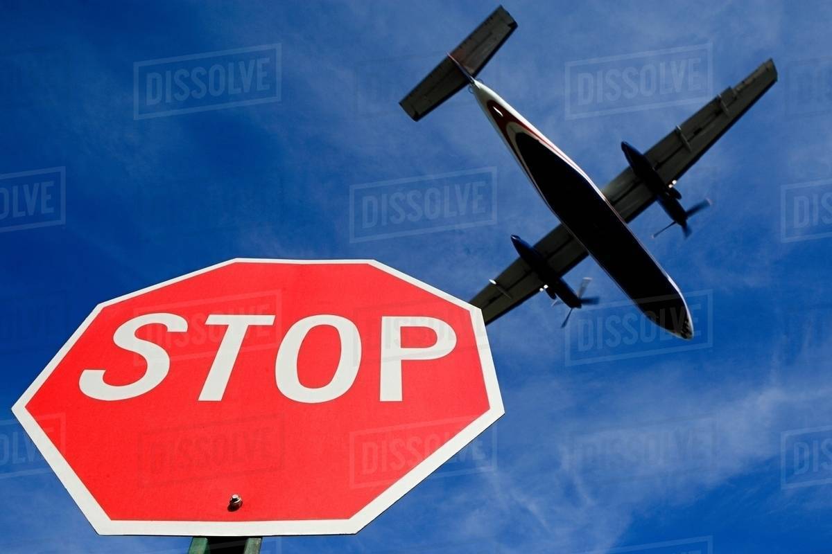 Airplane and stop sign - Royalty-free Stock Photo | Dissolve