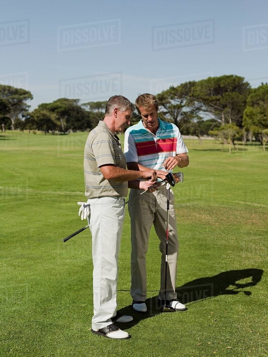 Two mature men playing golf together - Royalty-free Stock Photo | Dissolve
