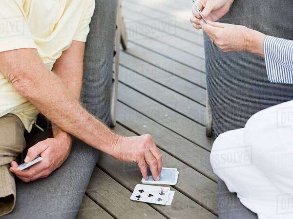People playing cards outdoors - Royalty-free Stock Photo | Dissolve