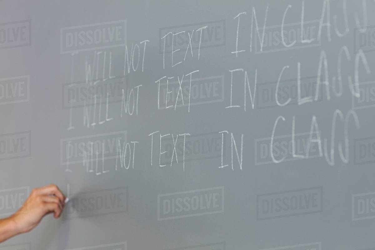 Male high school student writing lines on blackboard - Royalty-free ...