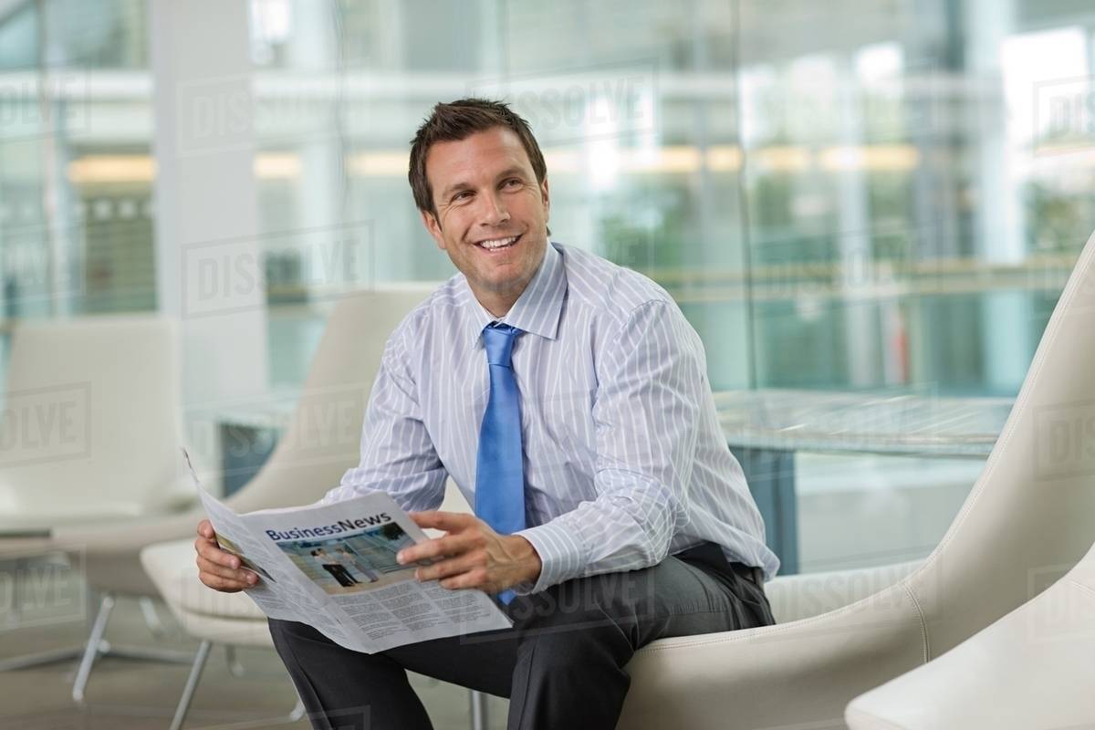 Businessman with magazine - Stock Photo - Dissolve