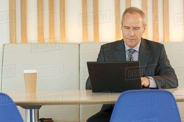 Businessman using laptop - Stock Photo - Dissolve