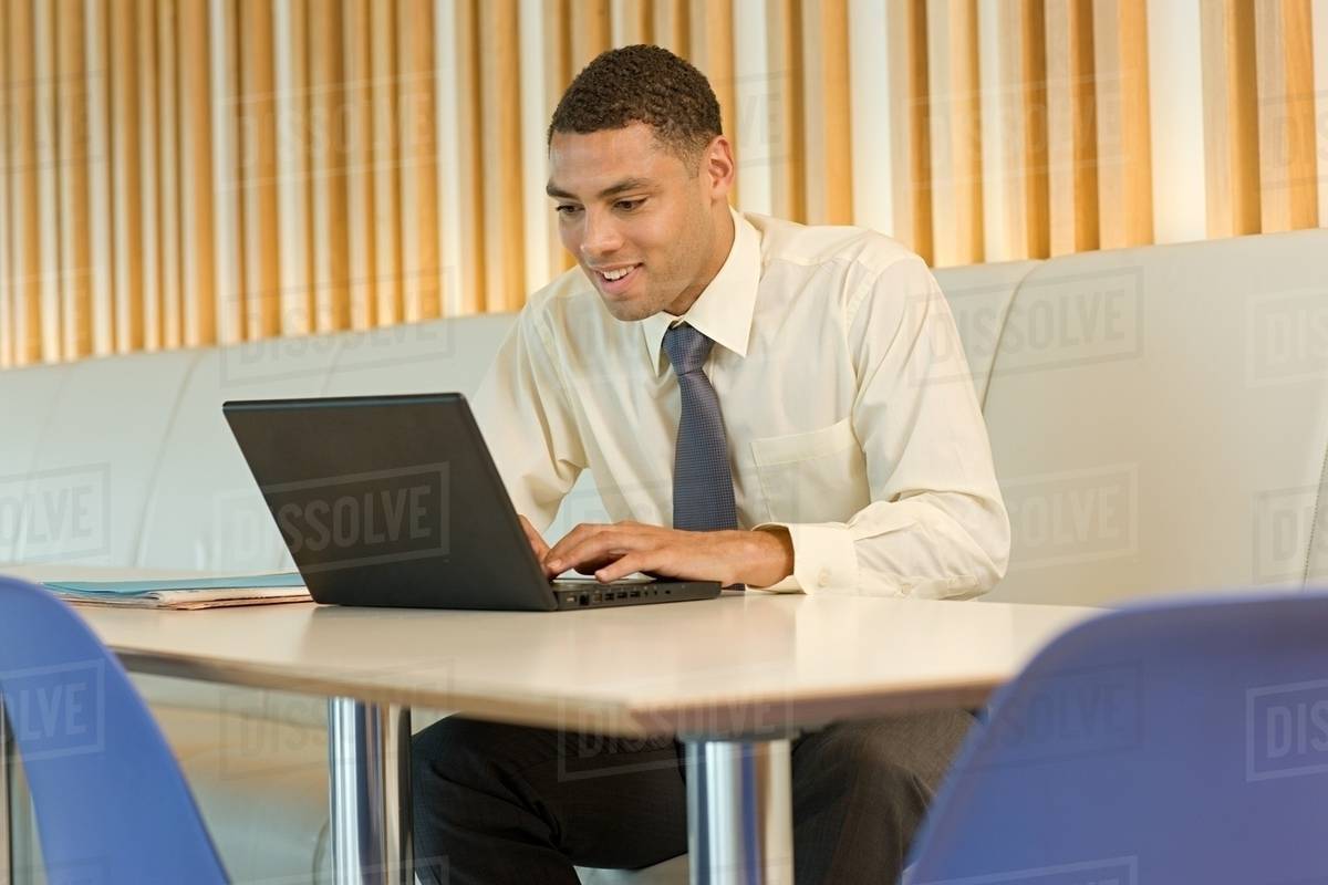 Businessman using laptop - Stock Photo - Dissolve