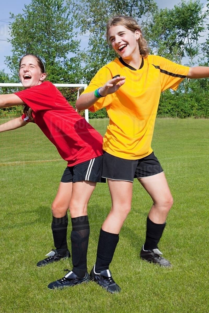 Girl soccer players messing around - Stock Photo - Dissolve