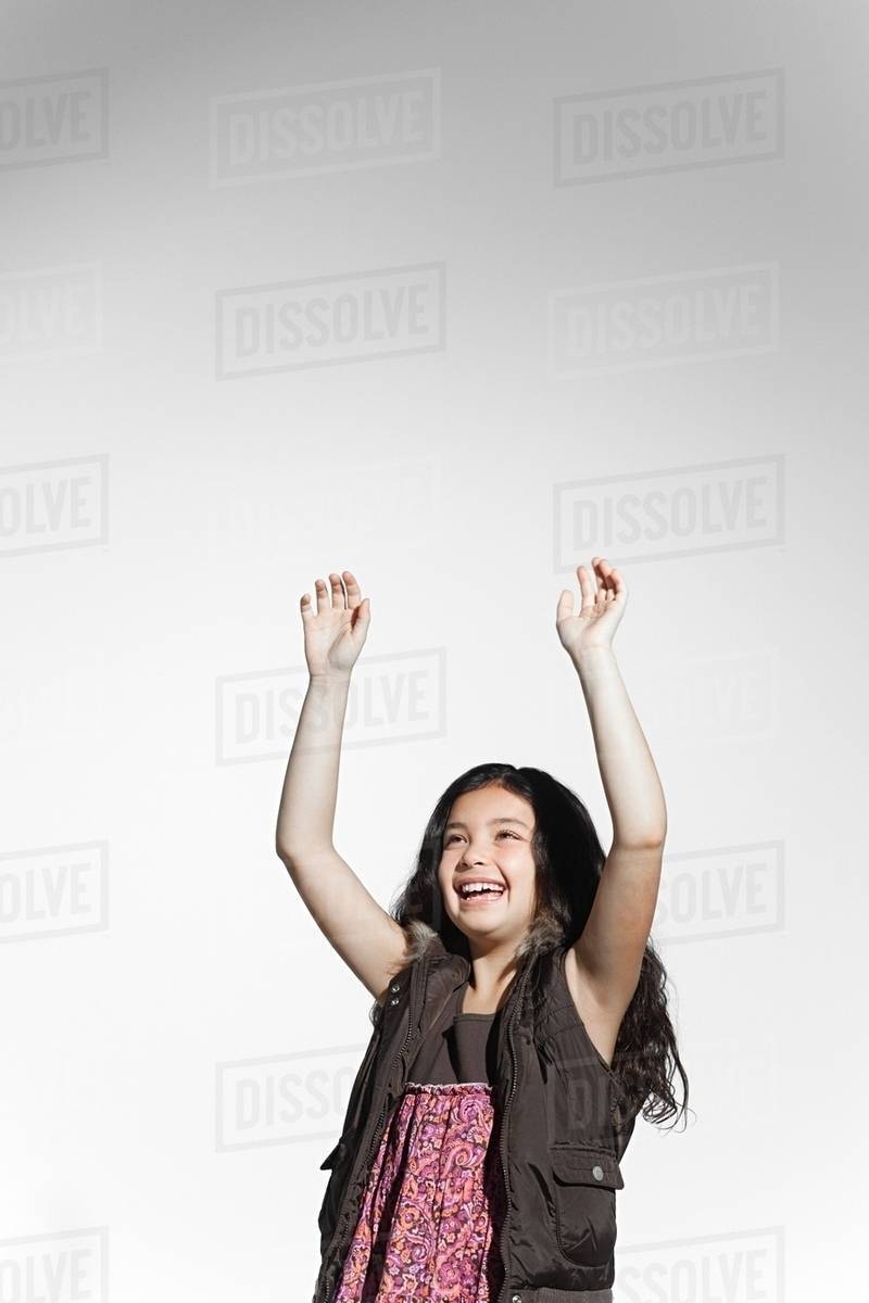 Happy girl with arms raised - Royalty-free Stock Photo | Dissolve