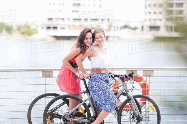 Two young women on a bicycle - Royalty-free Stock Photo | Dissolve