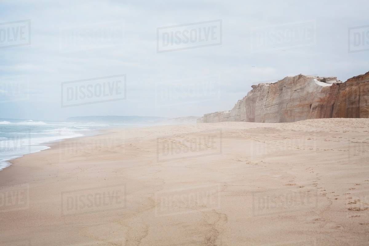 Peaceful beach scene with cliffs - Stock Photo - Dissolve